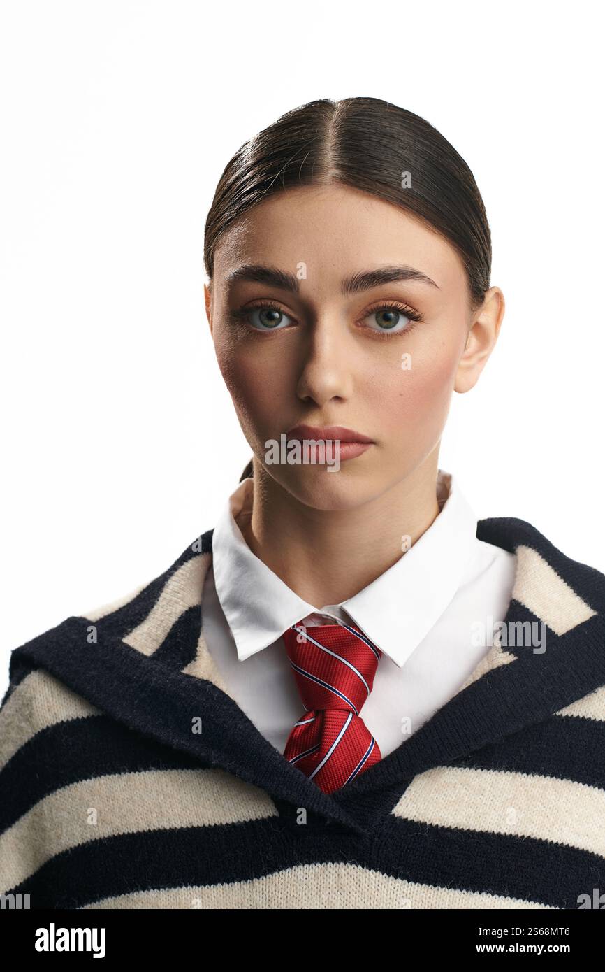 A beautiful young woman expresses deep emotions, wearing a striped ...