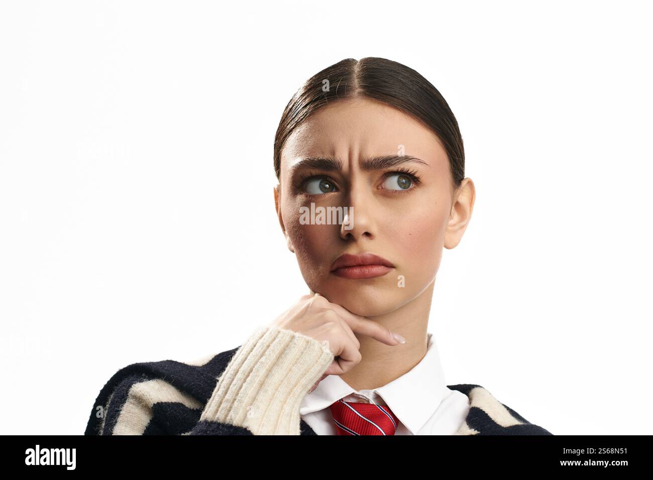 A beautiful young woman displays an emotional expression while deep in ...