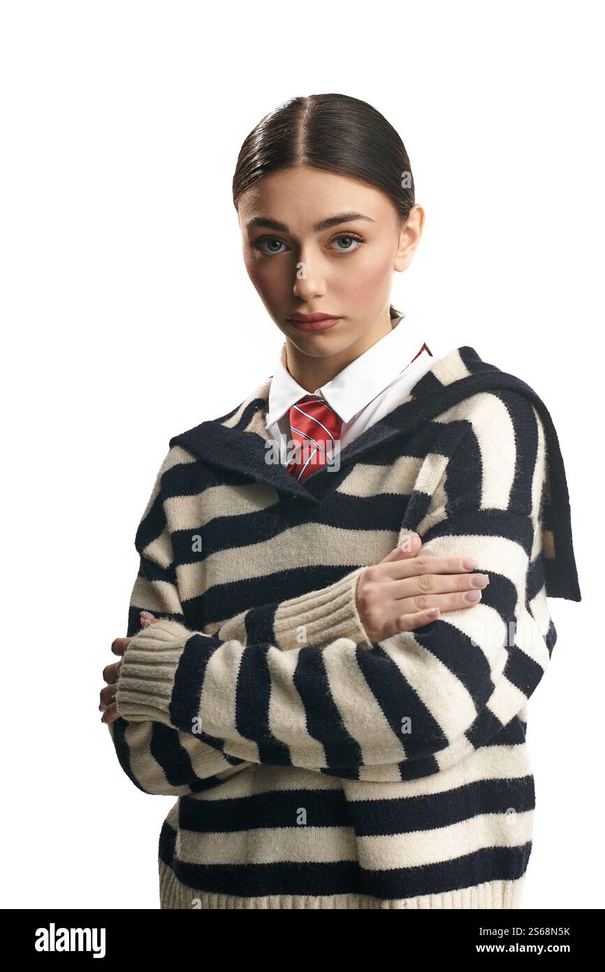 A beautiful young woman displays deep emotions while posing in a trendy ...