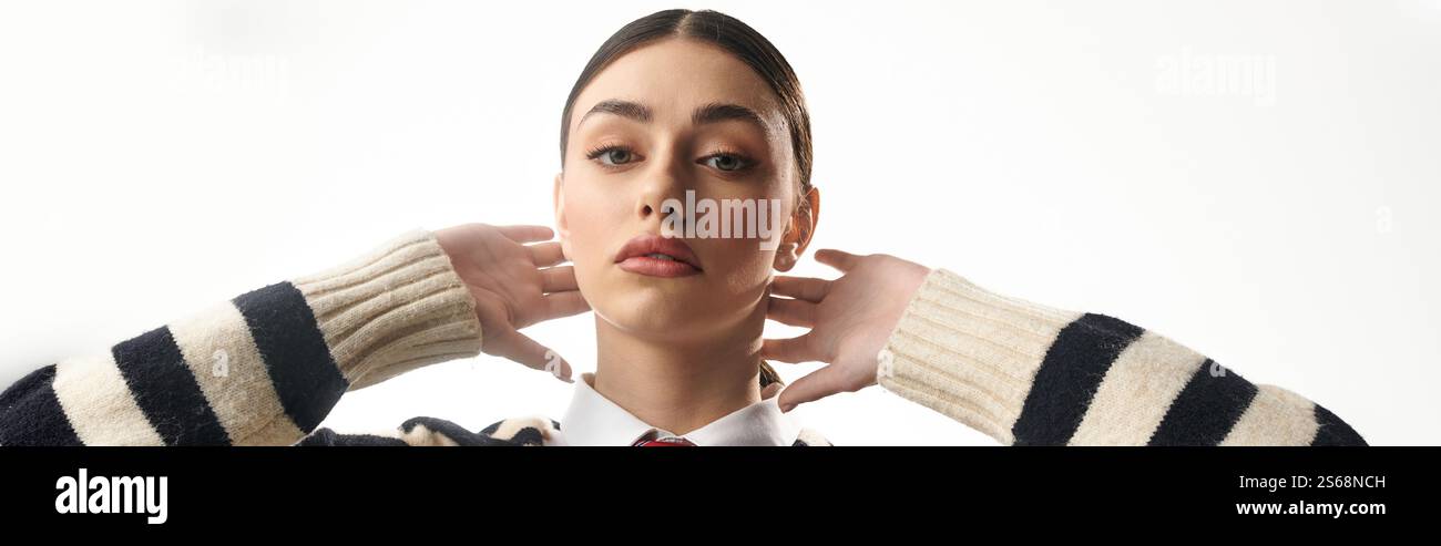 A young woman expresses bold emotions, hands near her face, radiating ...