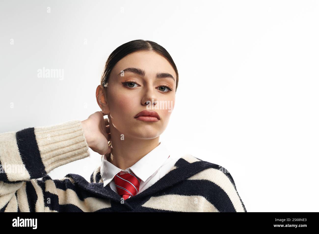 A young beautiful woman expresses deep emotions while elegantly posing ...