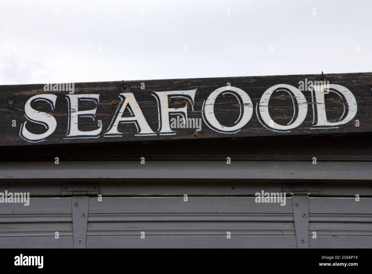 Close-up of a Seafood sign on the exterior of a refreshments kiosk at ...
