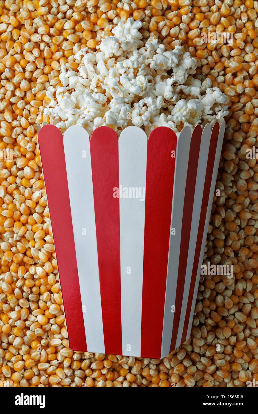 popcorn in carton box on corn grain background Stock Photo - Alamy