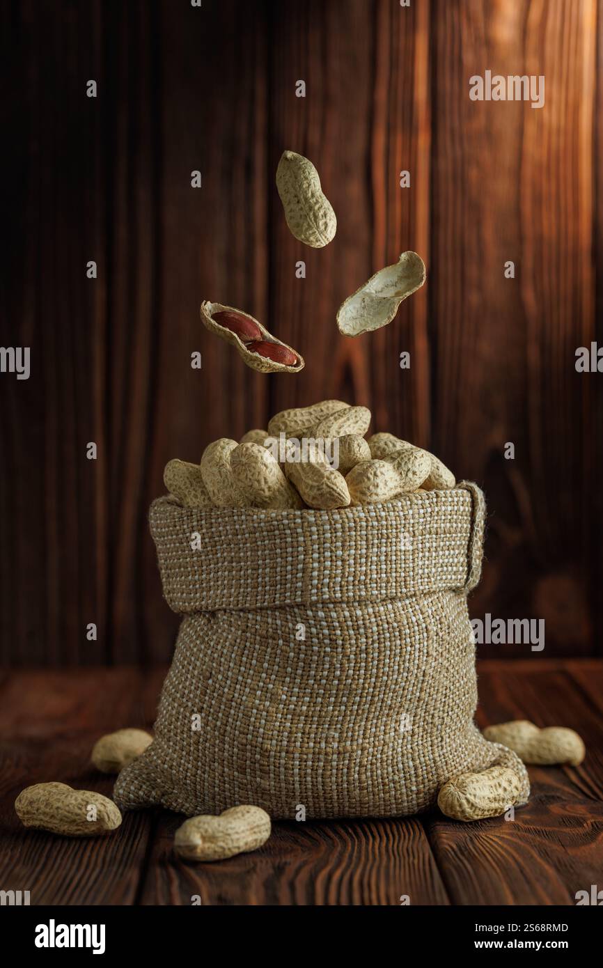 Unshelled peanuts falling on wooden hi-res stock photography and images ...