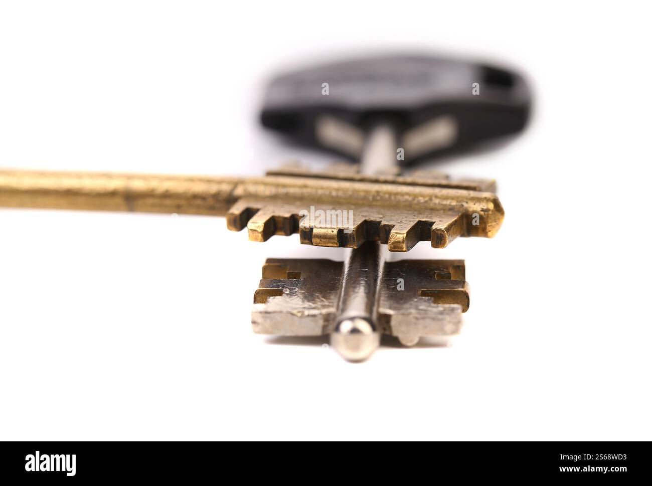 Golden and dark keys. One above the other. White background Stock Photo ...