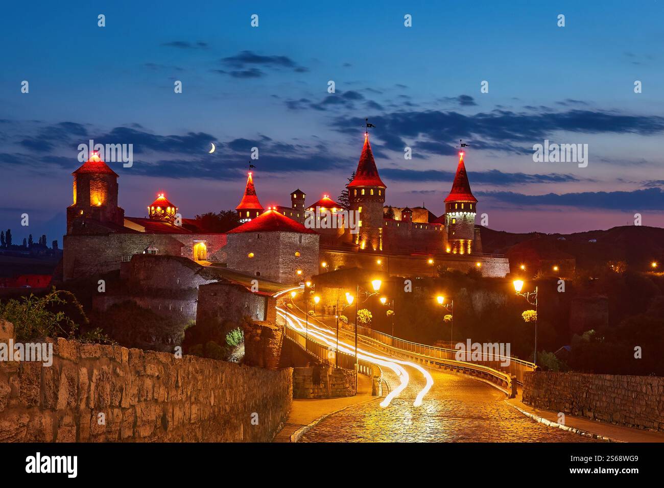 Night panoramic view of medieval half-ruined castle in Kamenetz-Podolsk ...