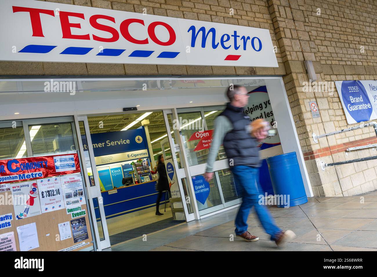 A shopper having finished their shopping is pictured walking out of the ...