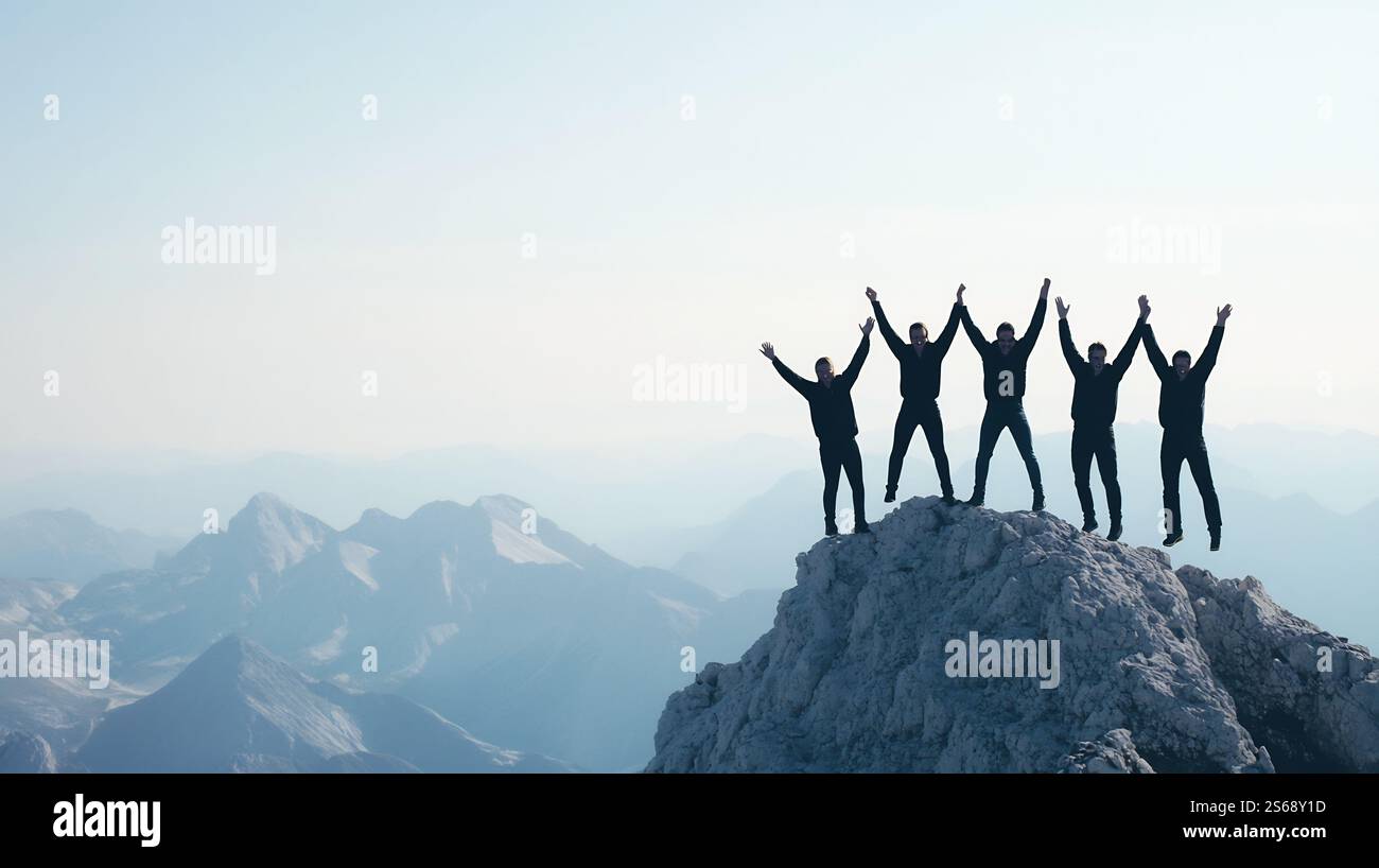 A group of friends raise their arms in after successfully reaching the ...