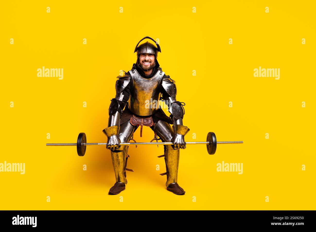 Medieval knight dressed in full armor lifting weights against a vibrant ...