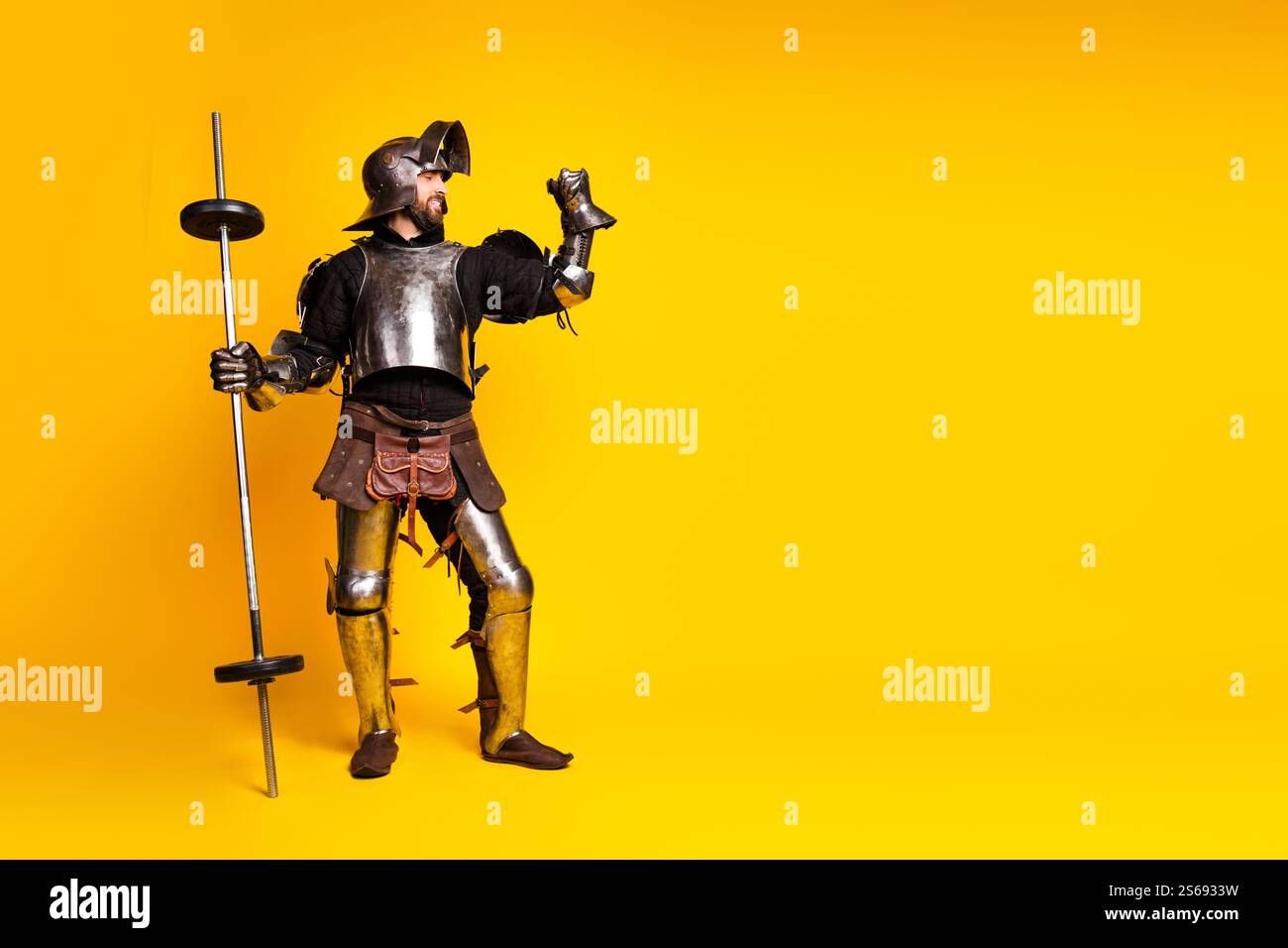 Medieval knight in full armor with a weightlifting barbell over a ...