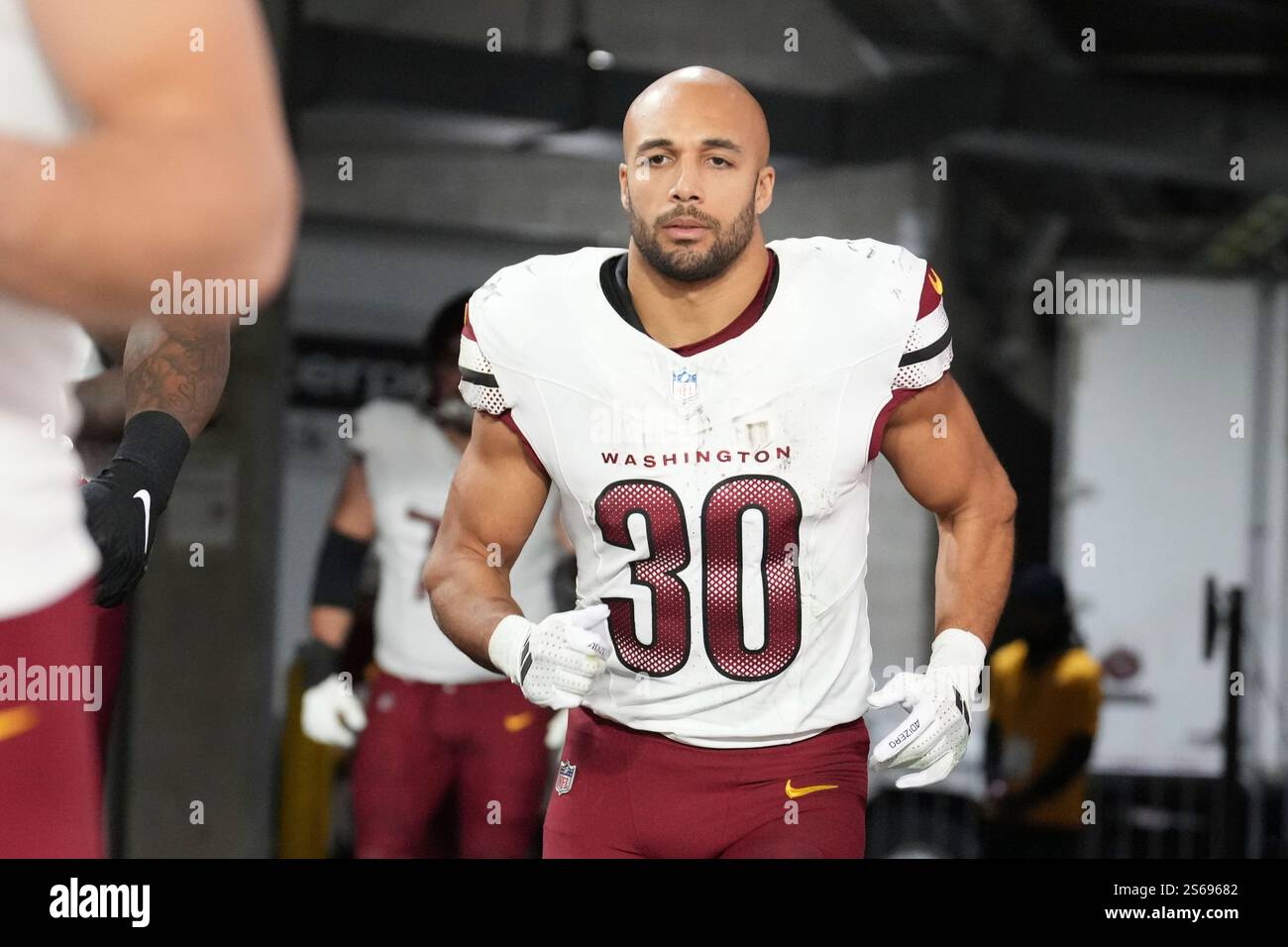 Washington Commanders running back Austin Ekeler (30) enters the field ...