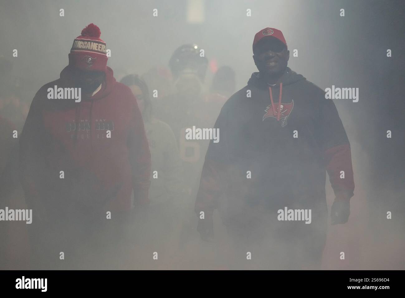 Tampa Bay Buccaneers head coach Todd Bowles walks through the smoke to ...