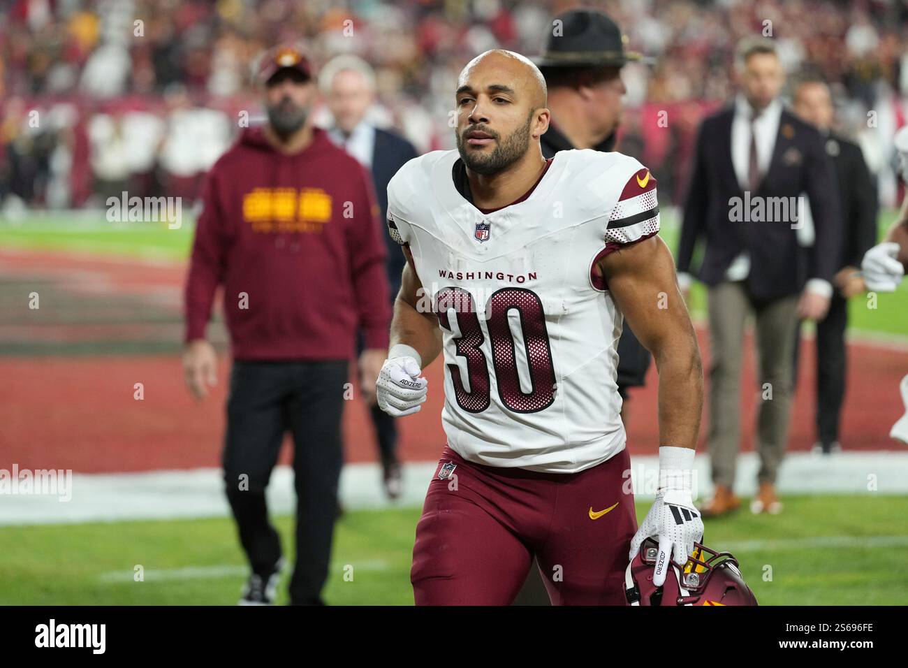 Washington Commanders running back Austin Ekeler (30) enters the locker ...