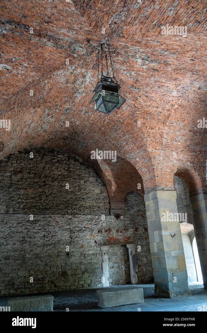 A medieval interior showcasing an intricately arched brick ceiling, a ...