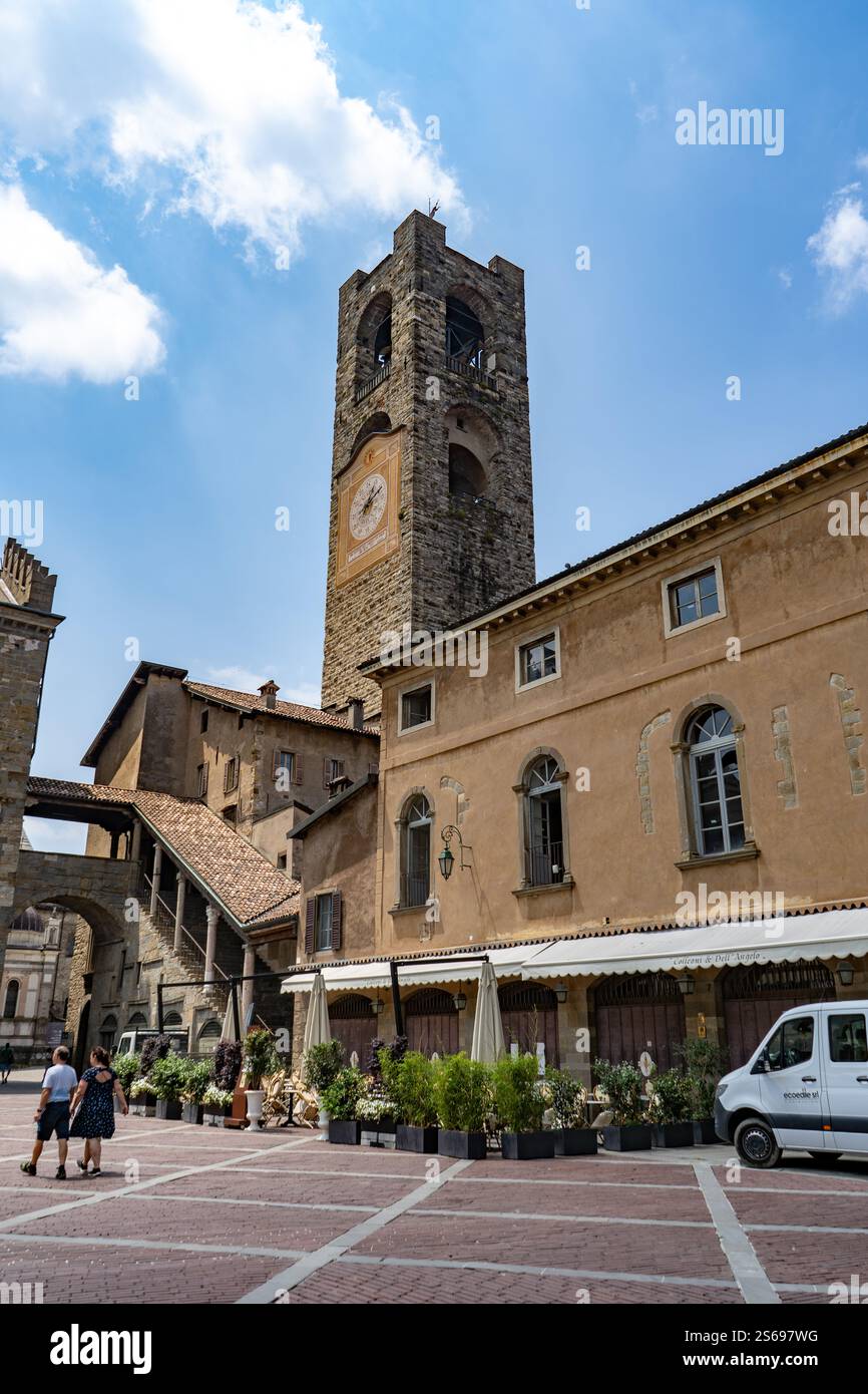 A picturesque clock tower in a historic town square, featuring stone ...