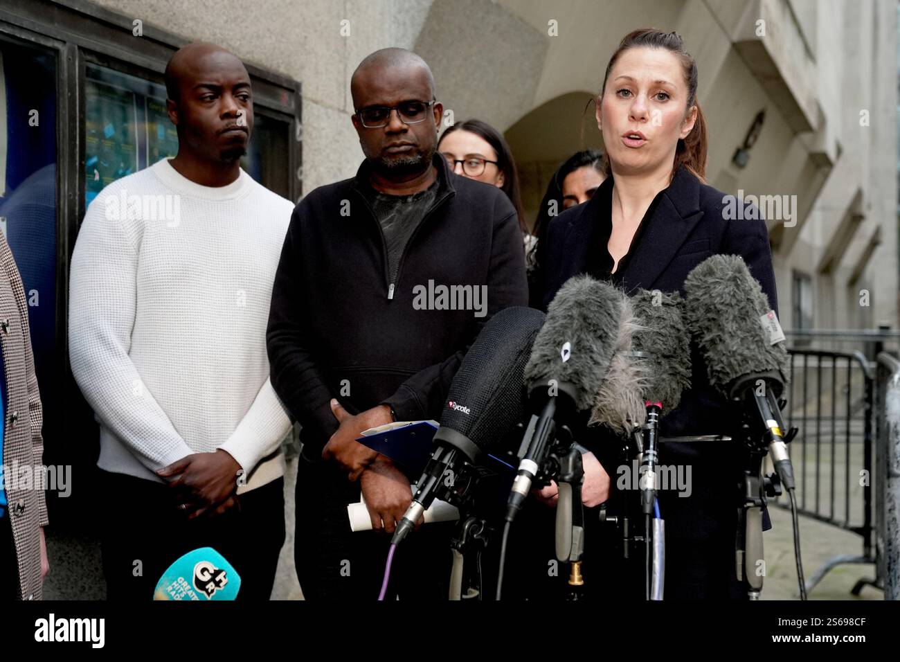 Michael Andam (centre), the father of Elianne Andam is accompanied by ...