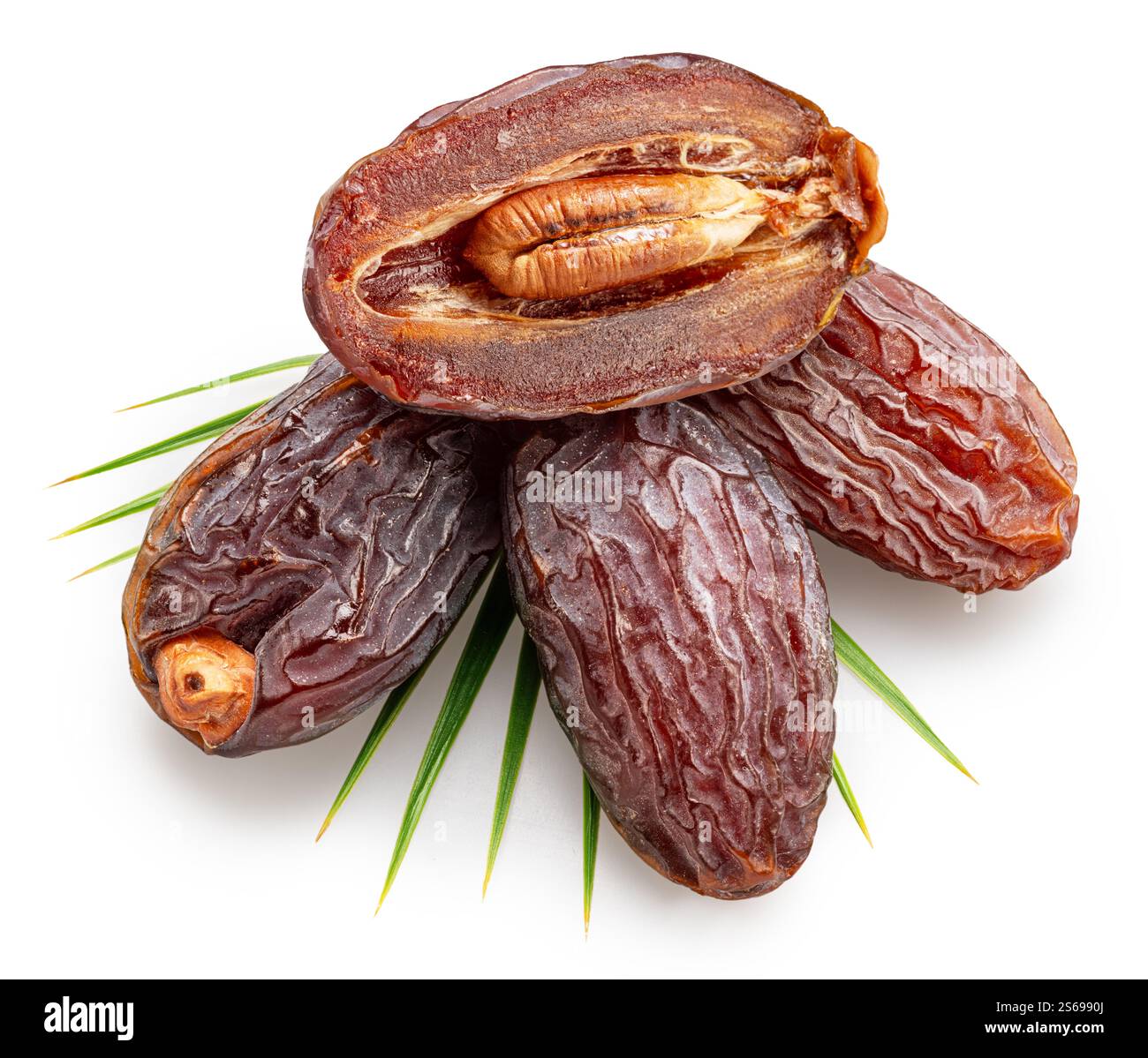 Semi-dried dates or date palm fruits lie on palm leaves isolated on ...