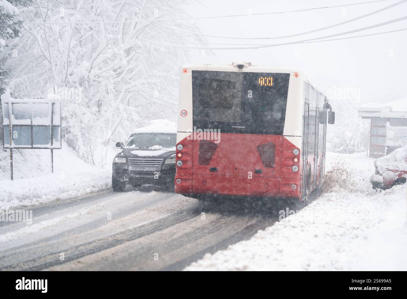 City bus on a city street during snowfall Stock Photo - Alamy