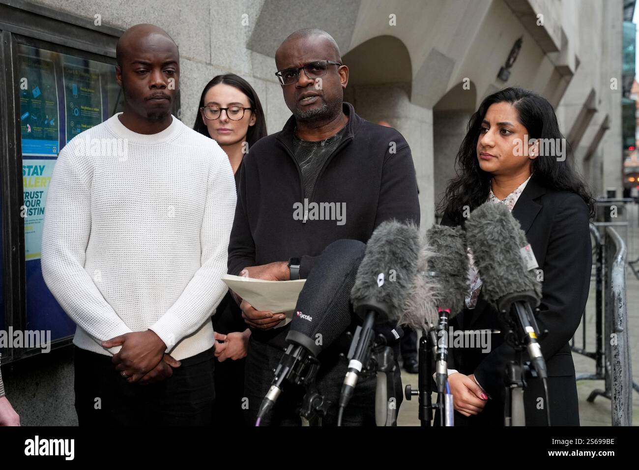 Michael Andam (centre), the father of Elianne Andam is accompanied by ...