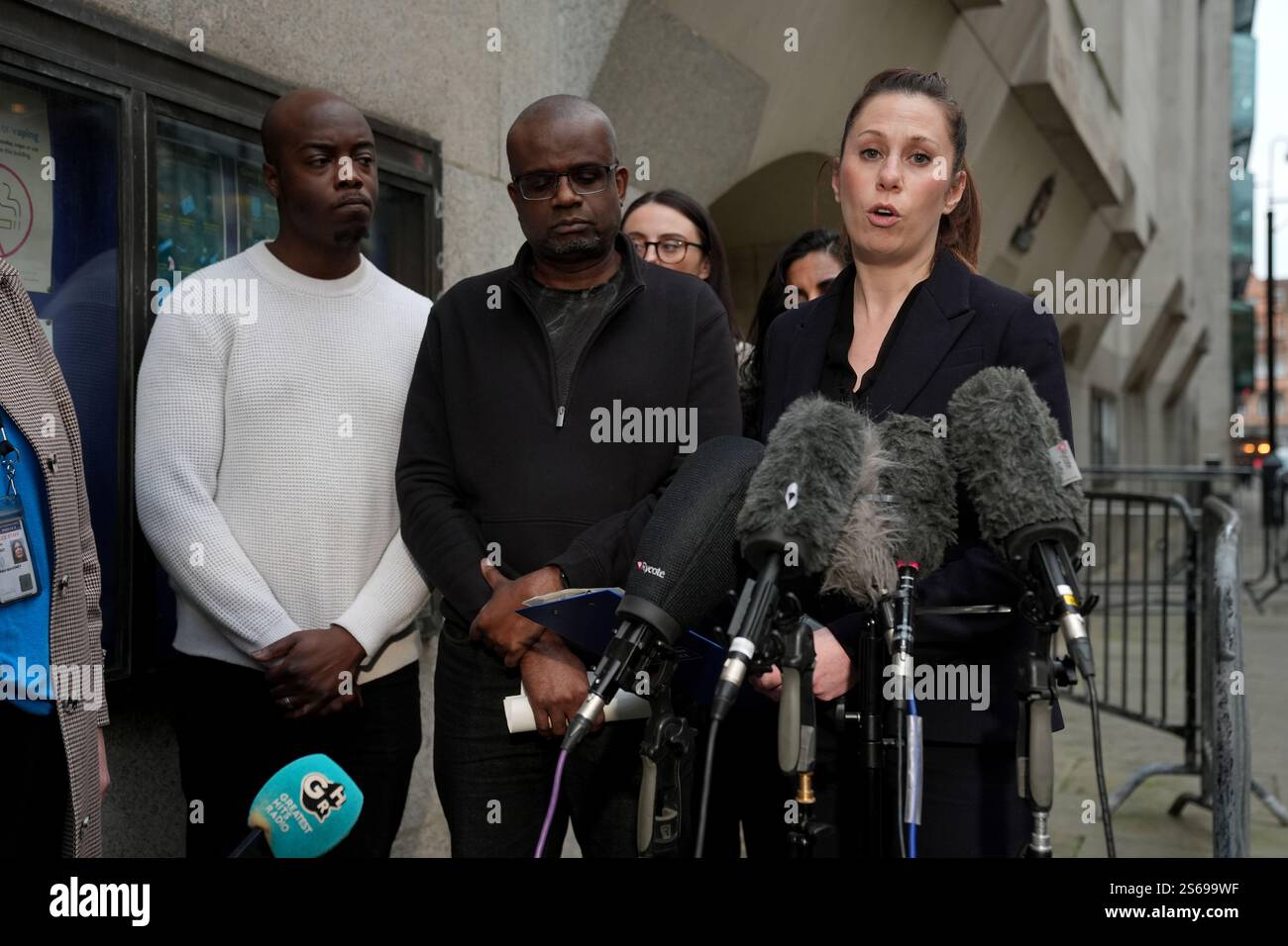 Michael Andam (centre), the father of Elianne Andam is accompanied by ...
