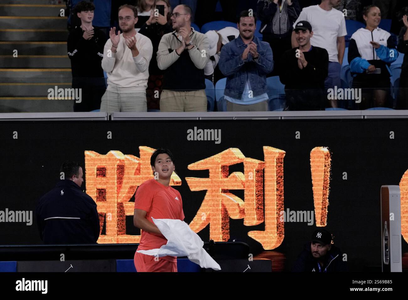 Learner Tien of the U.S. celebrates near the Chinese characters for ...
