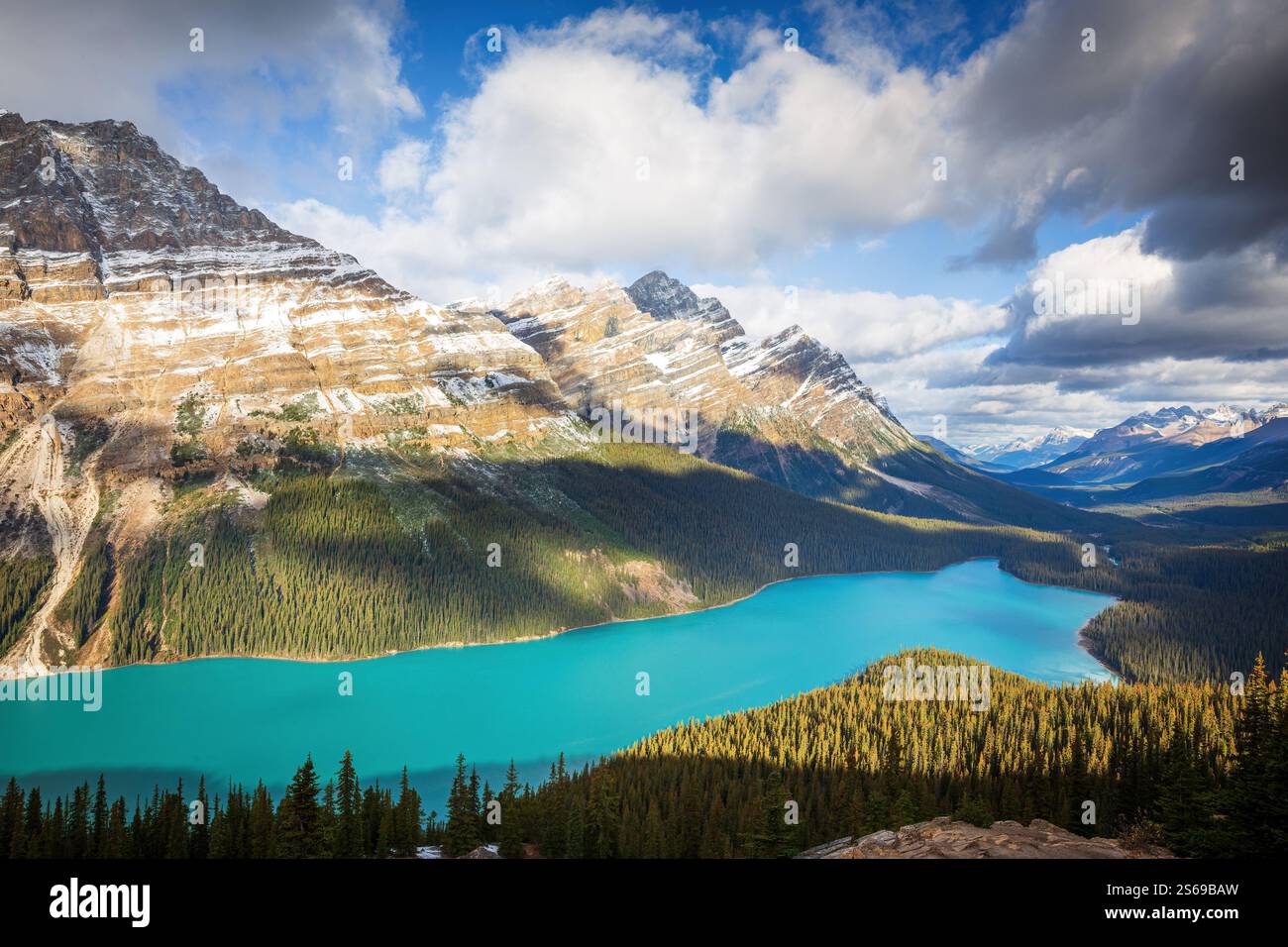 Morning light reveals Peyto Lake’s turquoise waters surrounded by snow ...