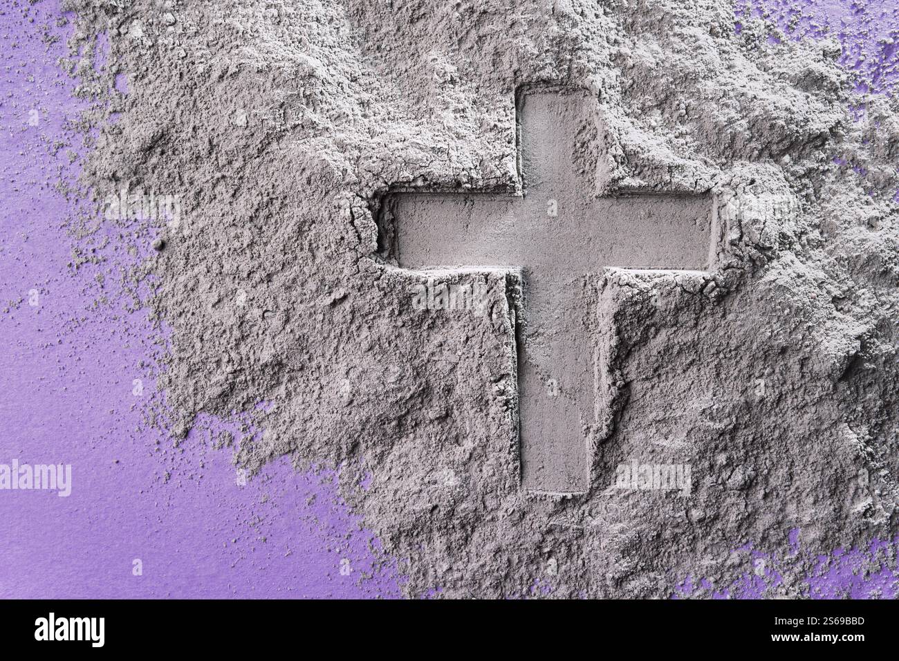Cross imprint in gray ash on purple surface: Ash Wednesday symbolism ...