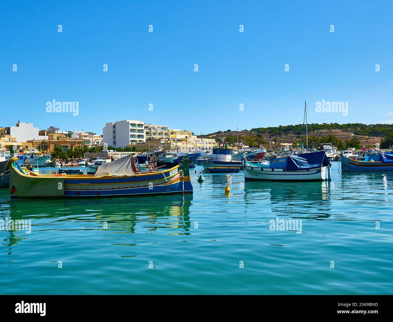 Traditional fishing boats in Marsaxlokk harbor. Marsaxlokk is one of ...