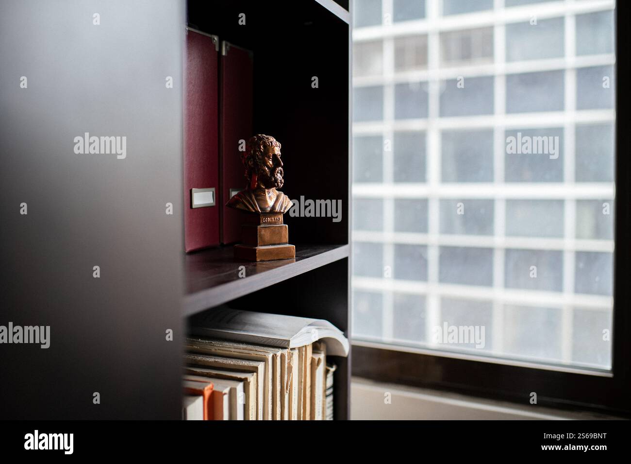 A lawyer’s office with bookshelves, antique clocks, and a Lady Justice ...