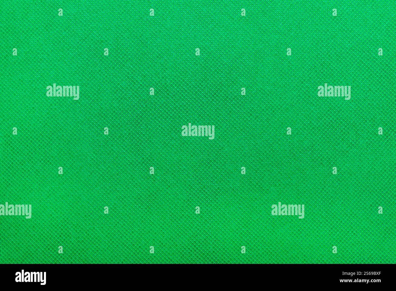 a close-up of a green fabric featuring a fine textured pattern ...