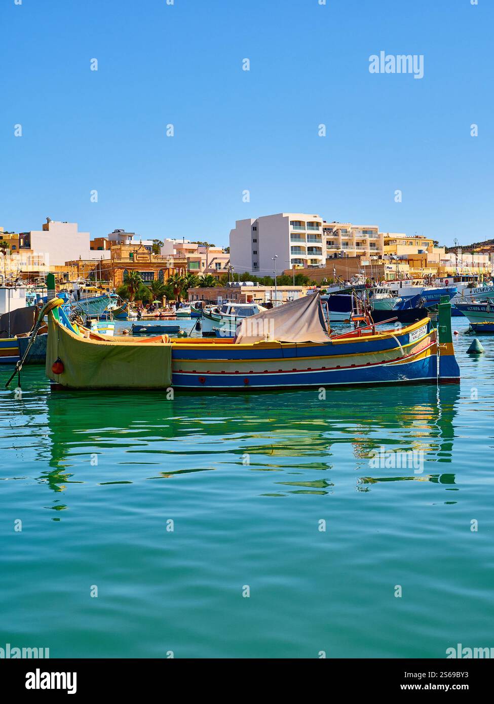 Traditional fishing boats in Marsaxlokk harbor. Marsaxlokk is one of ...