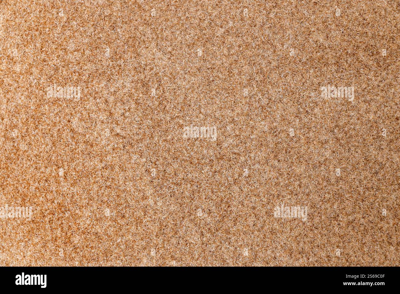 Close-up of coarse tan fabric with visible fibers, rough texture ...
