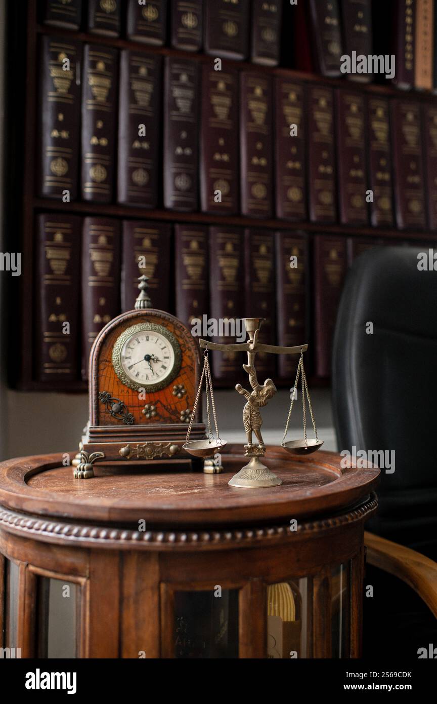 A lawyer’s office with bookshelves, antique clocks, and a Lady Justice ...
