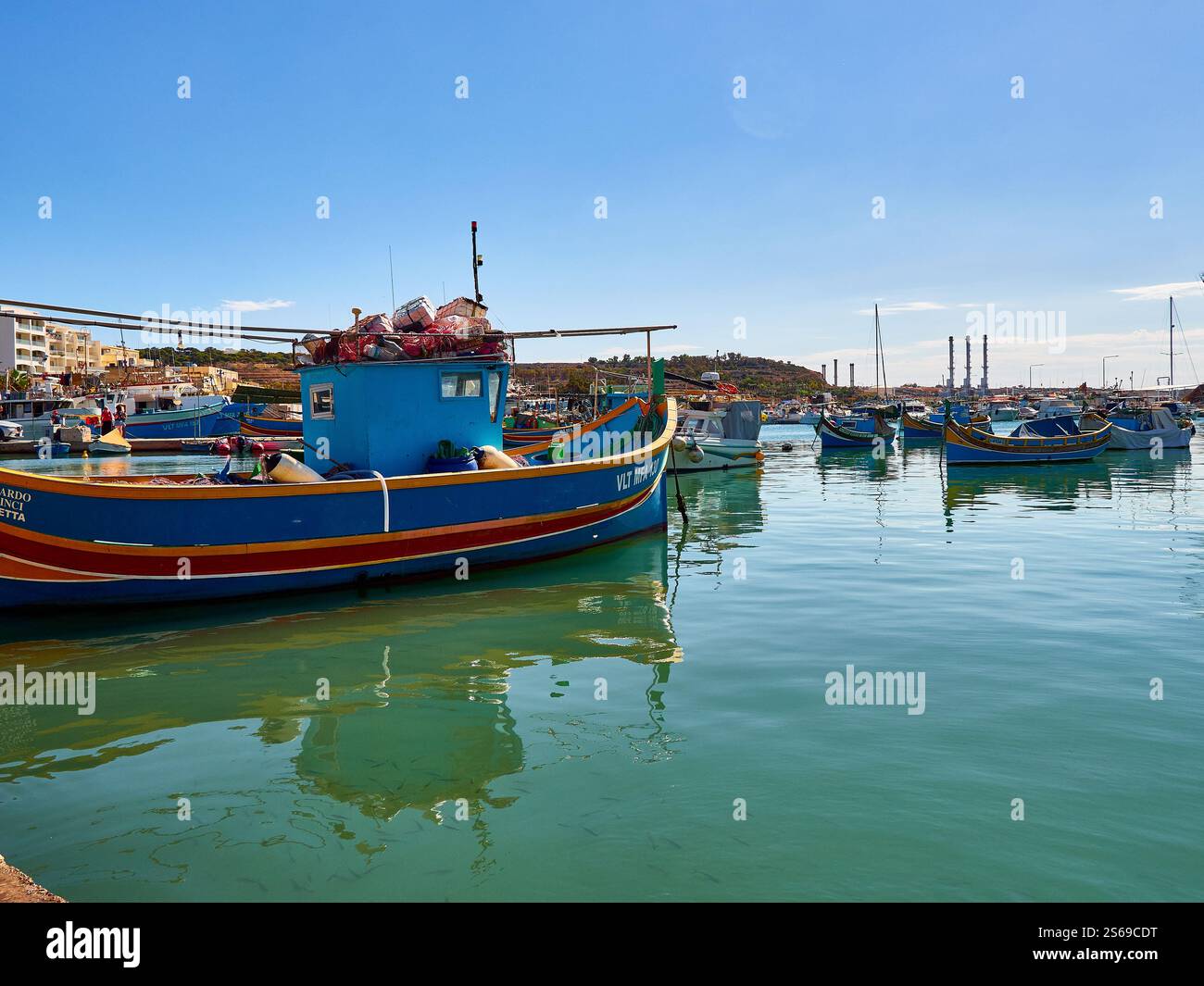 Traditional fishing boats in Marsaxlokk harbor. Marsaxlokk is one of ...