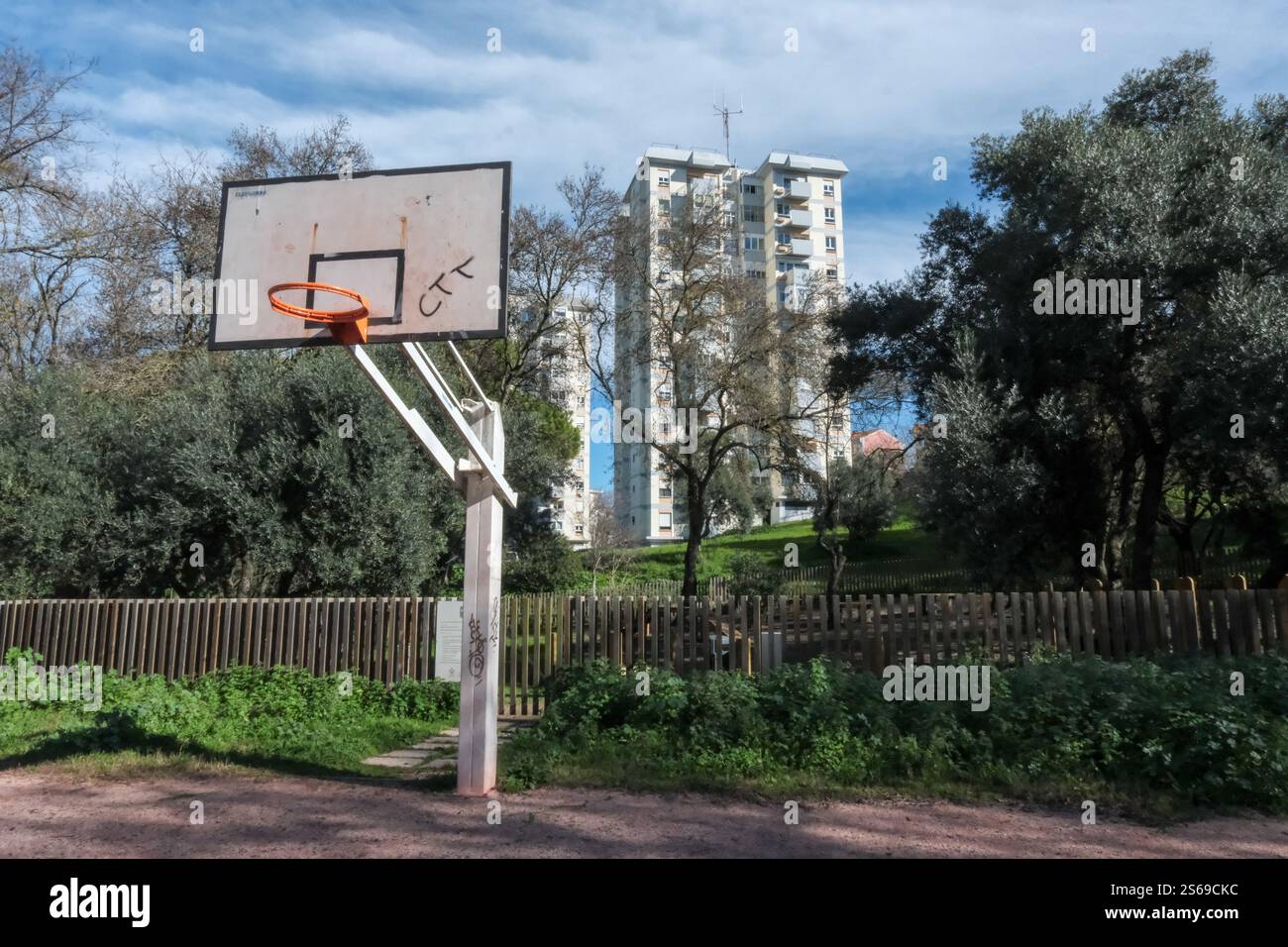 A basketball court and goal in a court area near to inner citty housing ...