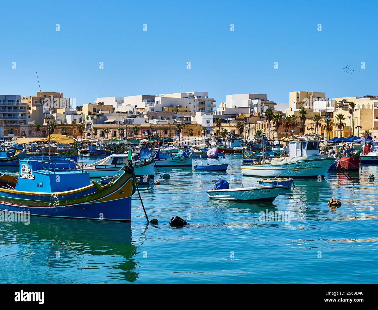Traditional fishing boats in Marsaxlokk harbor. Marsaxlokk is one of ...