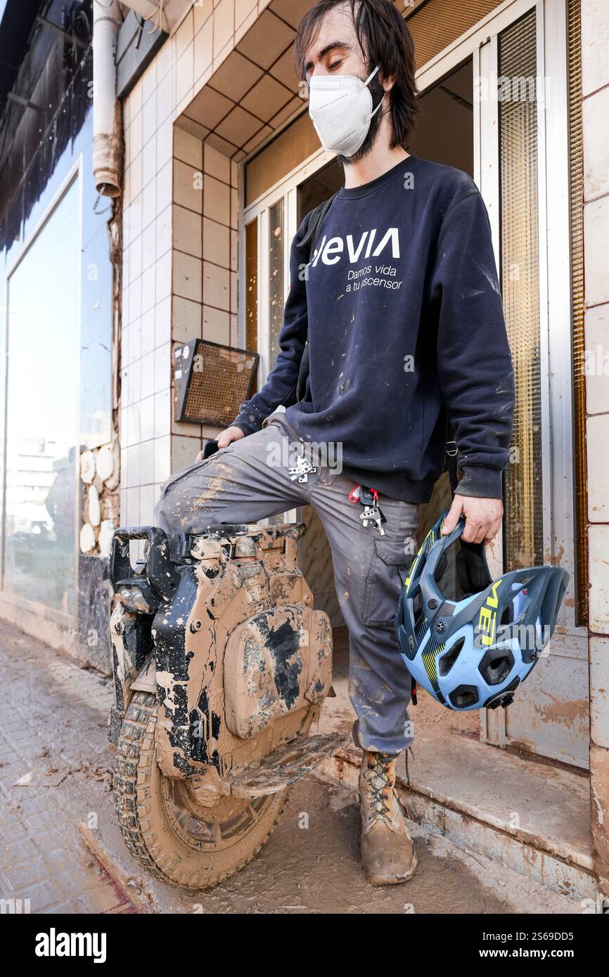 Young man wearing surgical mask PPE with helmet in his hand with an ...