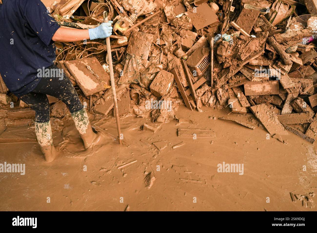 Unrecognizable person with muddy gumboots and dirty clothes in front of ...
