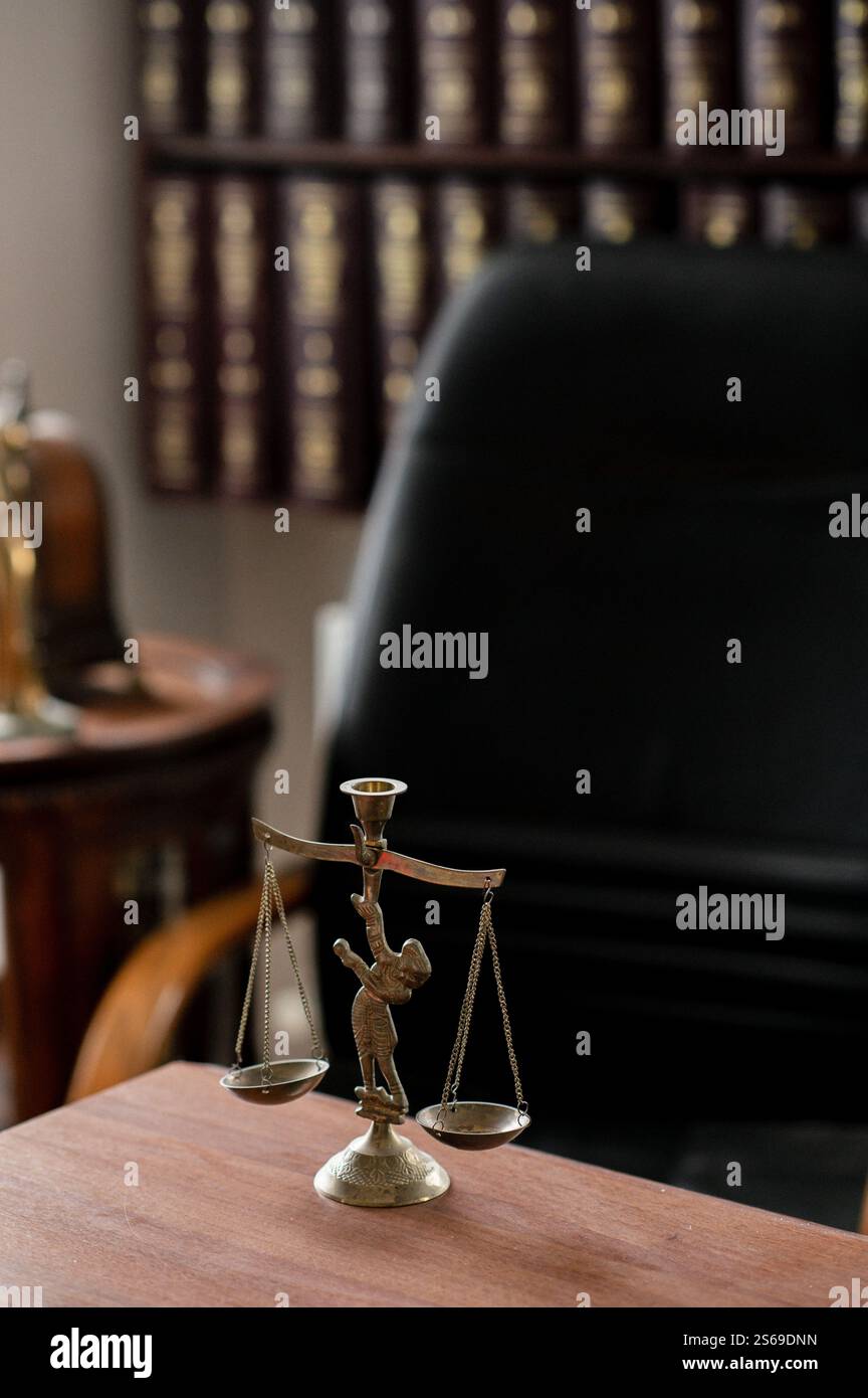A lawyer’s office with bookshelves, antique clocks, and a Lady Justice ...