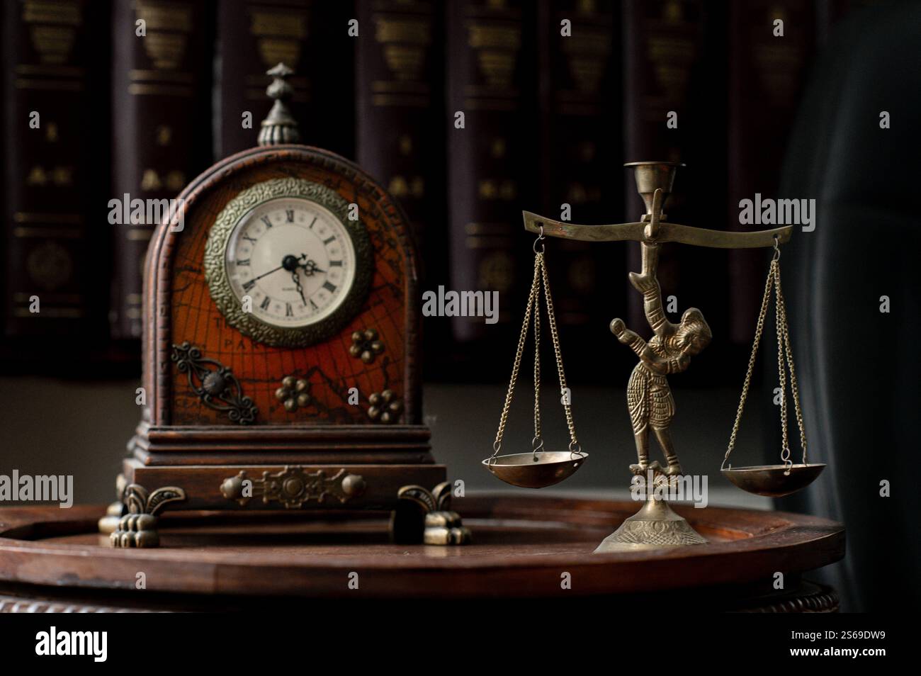 A lawyer’s office with bookshelves, antique clocks, and a Lady Justice ...