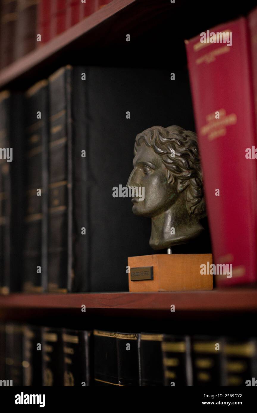 A lawyer’s office with bookshelves, antique clocks, and a Lady Justice ...