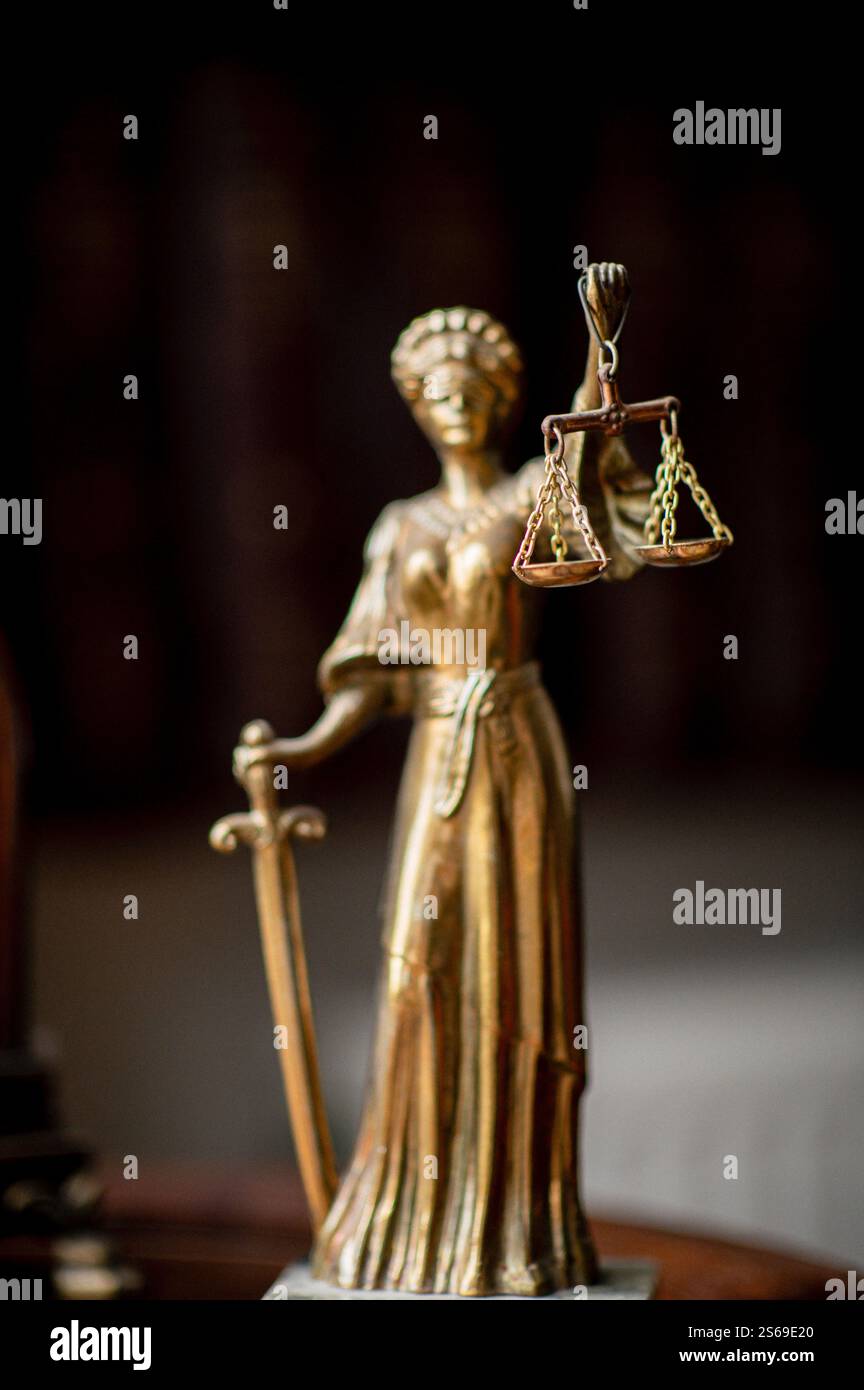 A lawyer’s office with bookshelves, antique clocks, and a Lady Justice ...