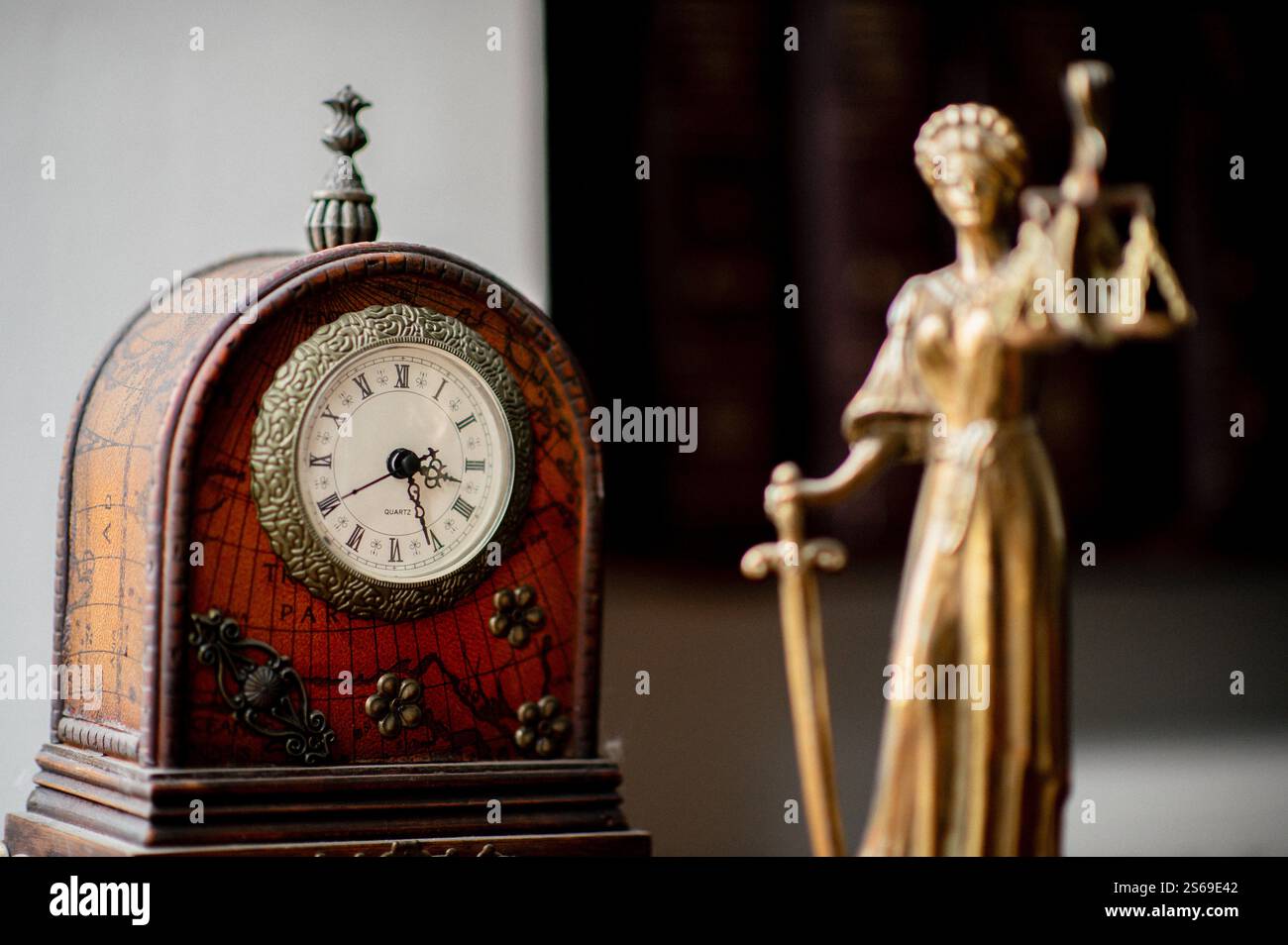 A lawyer’s office with bookshelves, antique clocks, and a Lady Justice ...