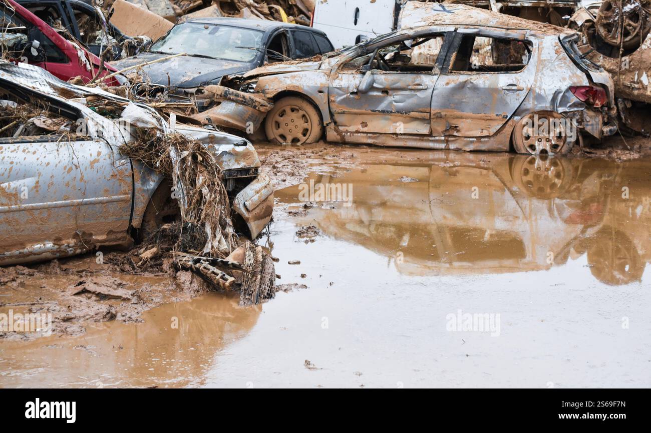 Destroyed cars covered in dirt stuck in the mud in outdoor parking ...