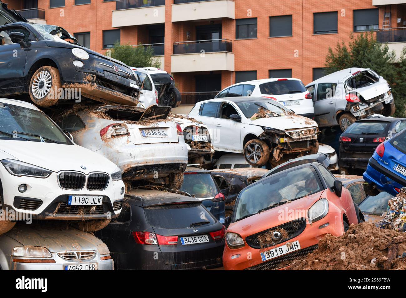 Damaged cars after DANA flooding are stored and piled up in fields and ...
