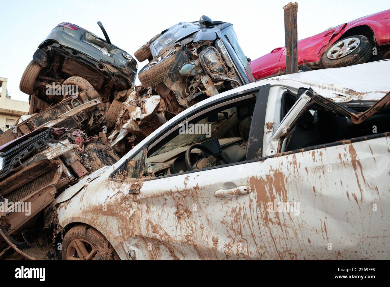 Crushed cars piled up and covered in mud after DANA floods. Alfafar ...