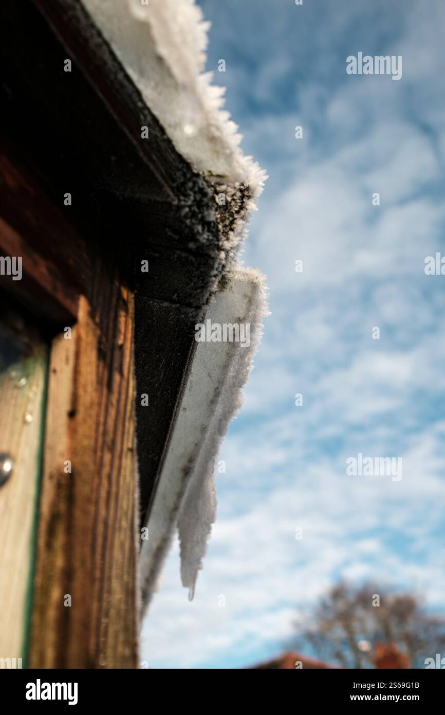 Snow and ice slipping off a greenhouse roof Stock Photo - Alamy