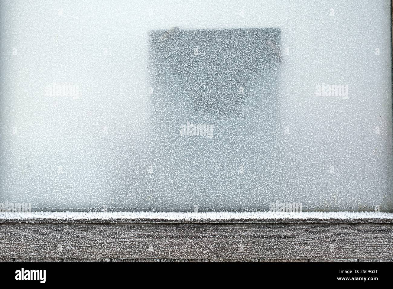 Frosted up greenhouse window Stock Photo - Alamy
