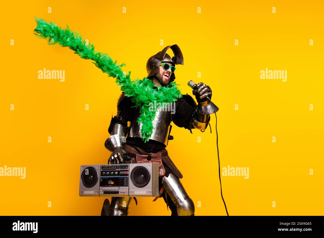 Humorous knight in full armor singing with a microphone and boombox ...