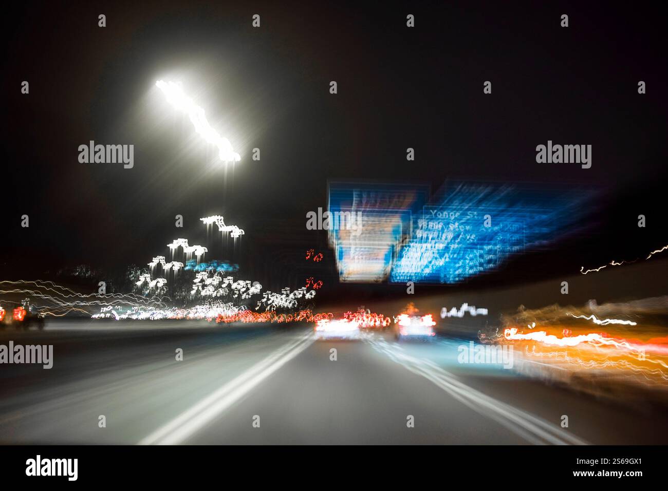 Cars, signs and lights on night city highway, motion blur created by ...